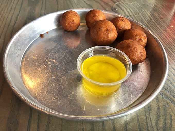 Those little golden orbs of fried cornmeal goodness are dangerously addictive with melted butter.