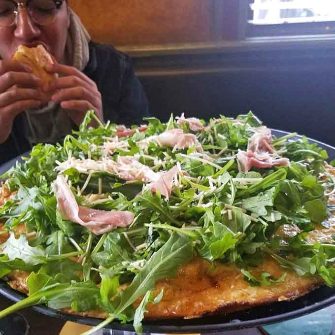 Fresh arugula piled high on a crispy crust creates the perfect excuse to call pizza a salad. We're not judging.