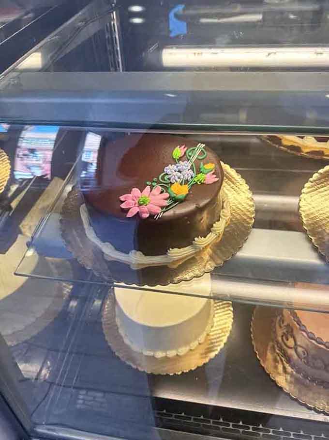 Rich chocolate ganache adorned with delicate flowers proves that elegance never goes out of style, thankfully.