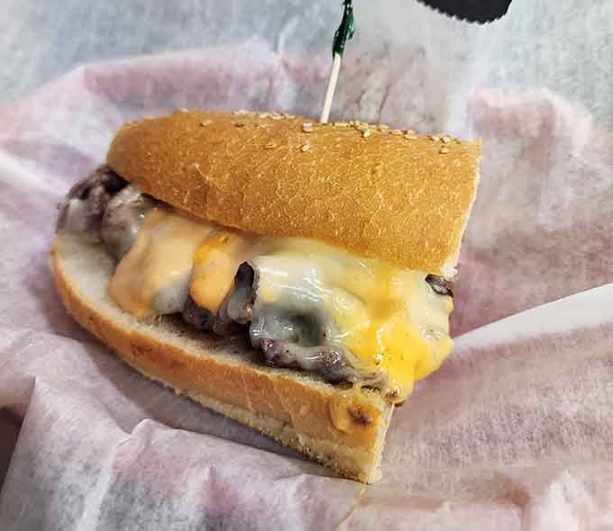 Melted cheese cascading over a cheesesteak like a delicious dairy waterfall of pure comfort food joy.