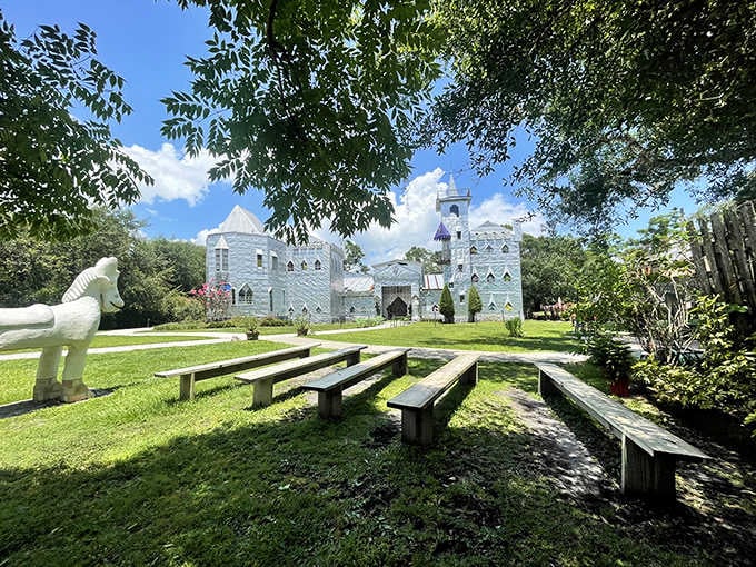 Wooden benches invite contemplation before a castle that defies every architectural rule you've ever known.