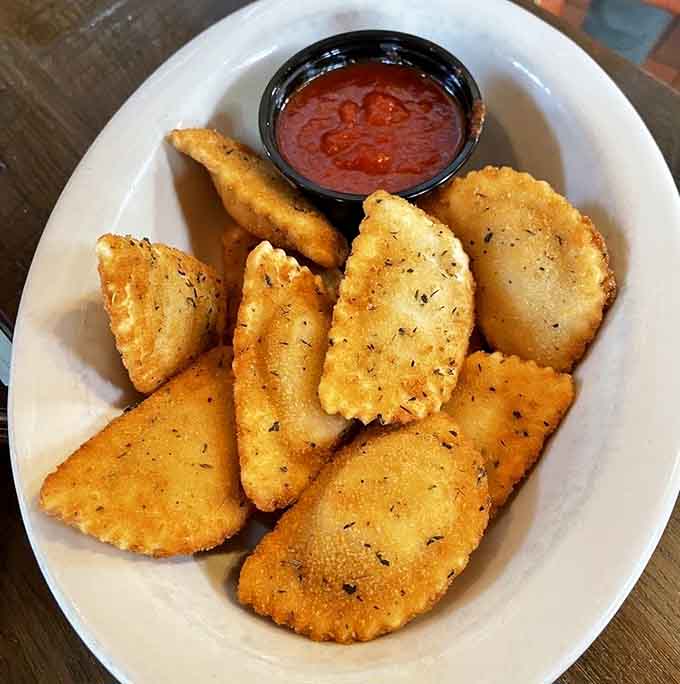 Golden pillows of fried perfection, because someone brilliantly decided ravioli needed a crispy makeover and we're forever grateful.