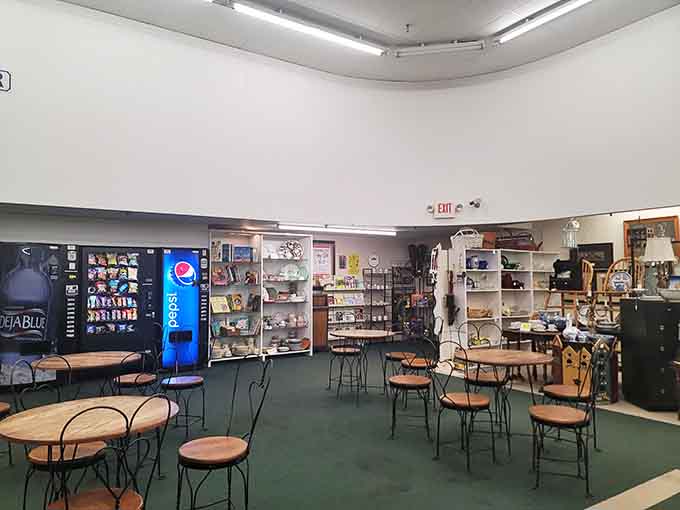 Take a breather in the seating area where vending machines meet vintage furniture in perfect antique mall harmony.