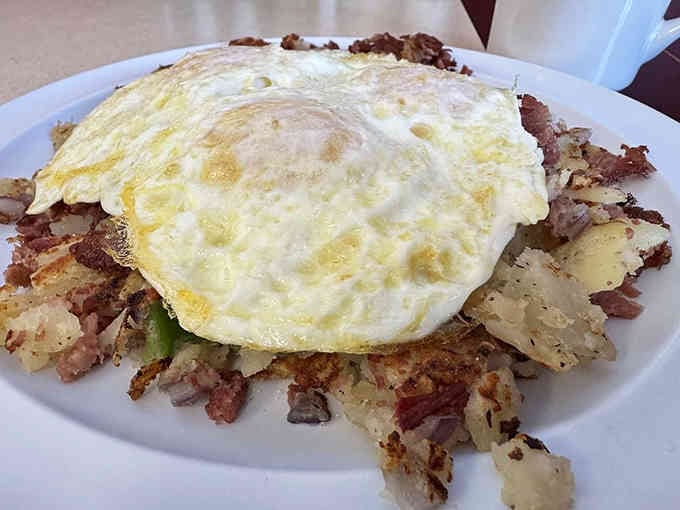 Crispy hash browns meet sunny eggs in a breakfast plate that could fuel an entire day of actual productivity.