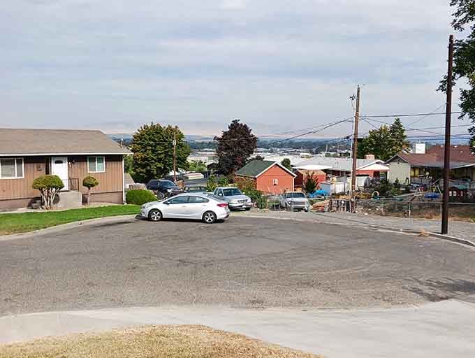 Residential streets where neighbors still wave instead of pretending you're invisible like city folk.