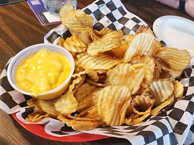 Those waffle-cut chips with cheese sauce are basically edible happiness served in a checkered basket of joy.