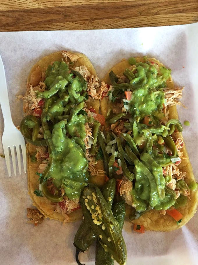 Corn tortillas topped with shredded chicken and that vibrant green salsa are calling your name right now.