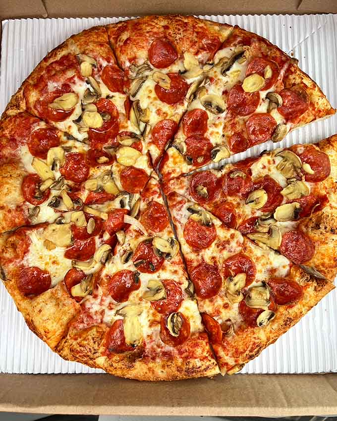 A deep dish masterpiece that's basically a cheese and pepperoni swimming pool you can eat with your hands.