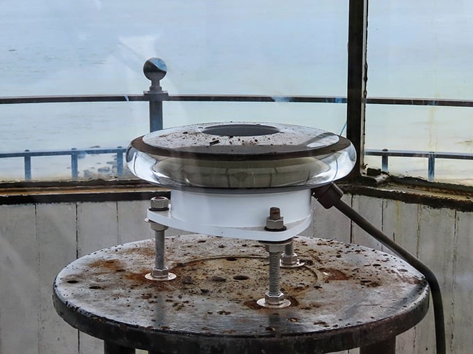 The Fresnel lens mechanism that once guided ships safely home, now a beautiful relic of innovation.