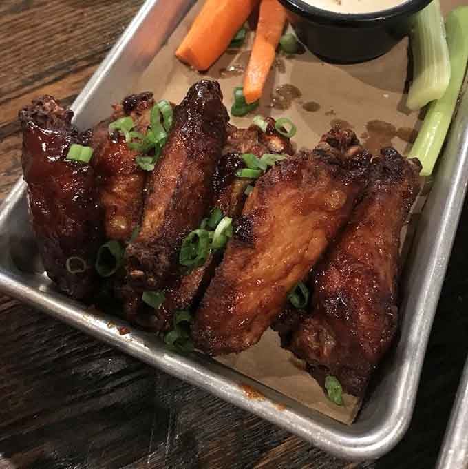 These glazed wings are glistening like they've been dipped in liquid gold and sprinkled with pure joy.