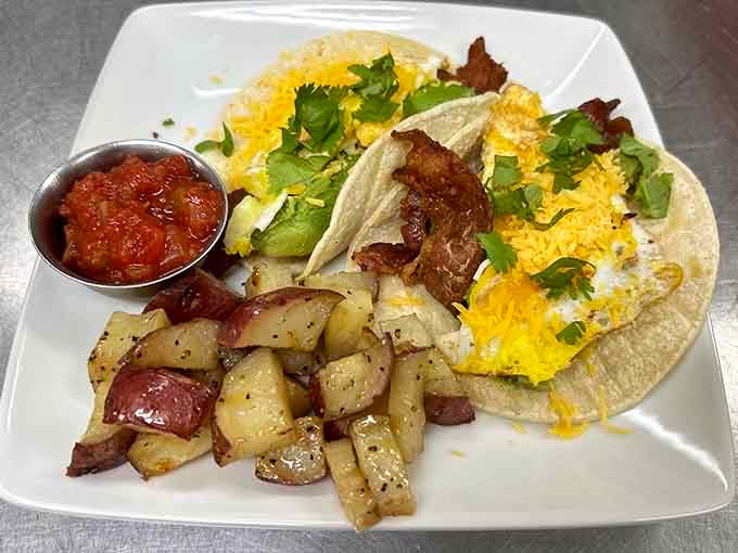 Breakfast tacos loaded with eggs, cheese, and crispy bacon, served with perfectly seasoned potatoes that shine like treasure.