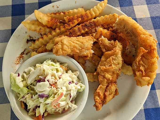 Fish and chips with enough batter to make British pub owners nod approvingly while clutching their own recipes tightly.