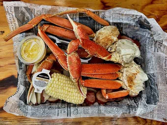 Snow crab legs sprawled across newspaper like they're posing for their own seafood magazine cover shoot.