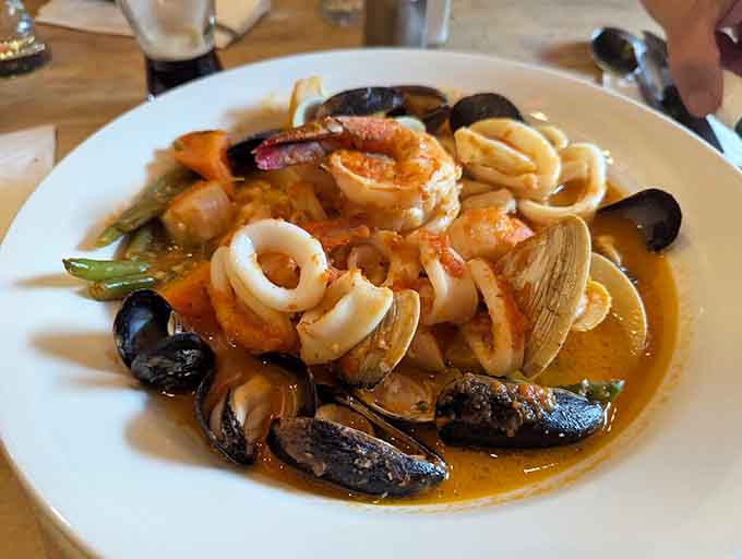 A seafood lover's jackpot: clams, mussels, shrimp, and calamari swimming together in tomato-based harmony that sings on your palate.