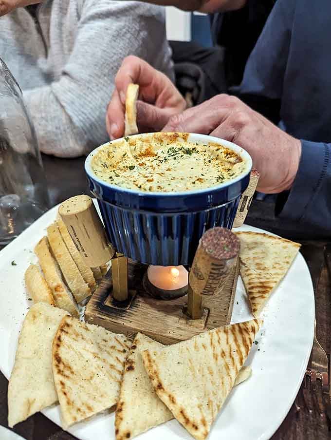 Hot crab dip with grilled flatbread proves that sometimes the simplest presentations deliver the most spectacular flavors.