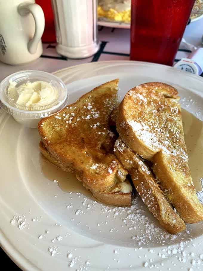 French toast dusted with powdered sugar arrives looking like breakfast won the lottery at The Gem Diner.