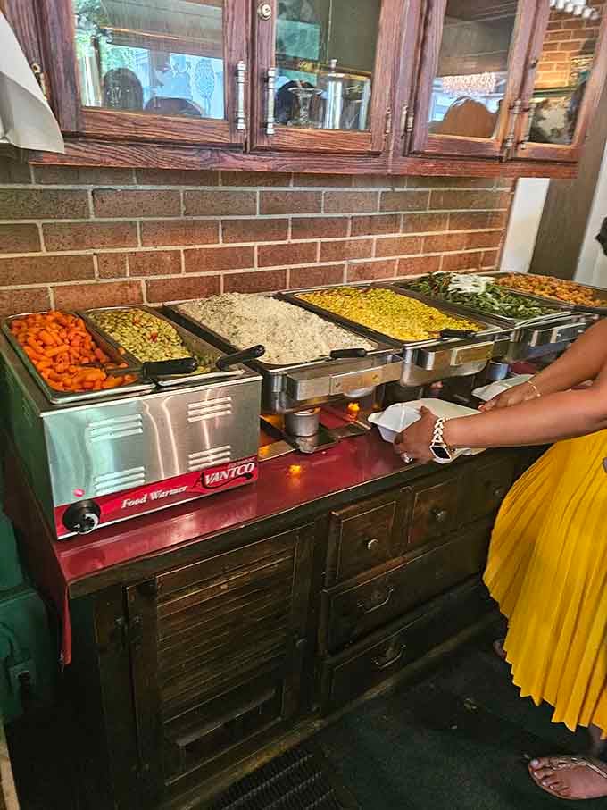 Carrots, lima beans, and rice stand ready in their warming trays, each vegetable cooked with genuine Southern care.