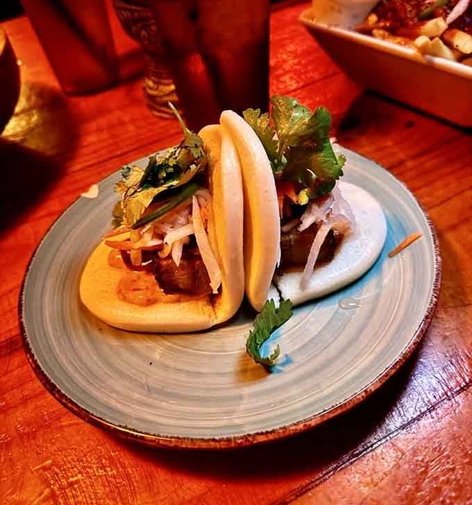 Pork belly bao that's basically a hug for your taste buds, served on fluffy steamed pillows of joy.
