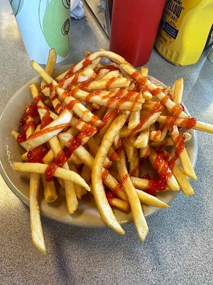French fries so generously portioned and perfectly crispy, they deserve their own standing ovation and ketchup waterfall.