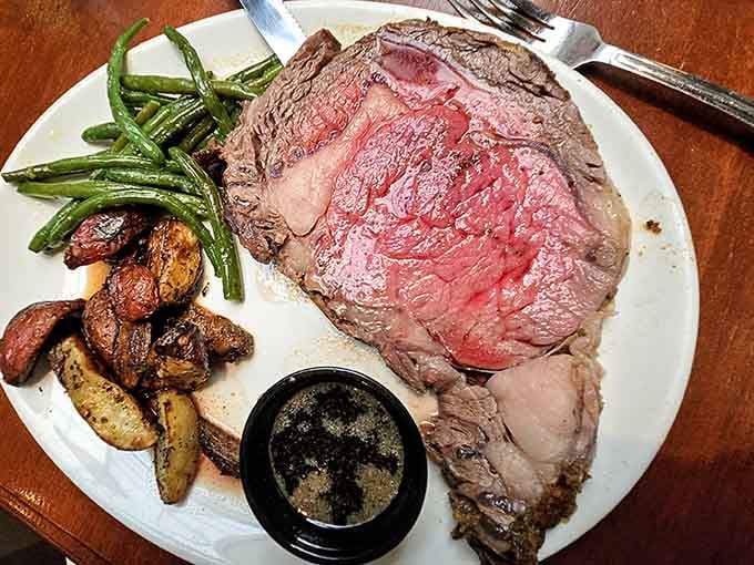 Look at that perfectly cooked prime rib with those roasted mushrooms and fresh green beans on the side.