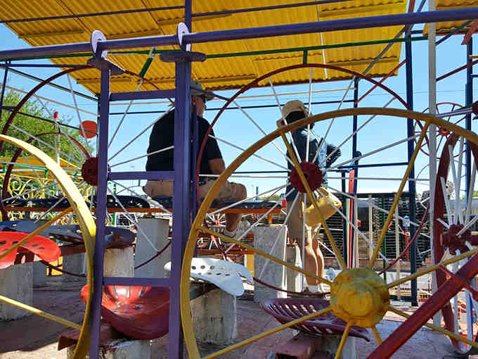 Visitors navigate the labyrinth of creativity, discovering new surprises around every colorful, wheel-adorned corner.