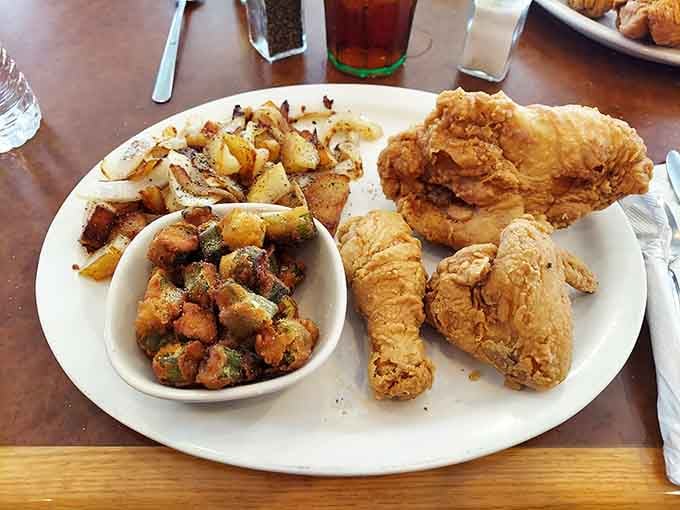 Fried chicken so golden it practically glows, surrounded by sides that know their supporting role is actually pretty important.