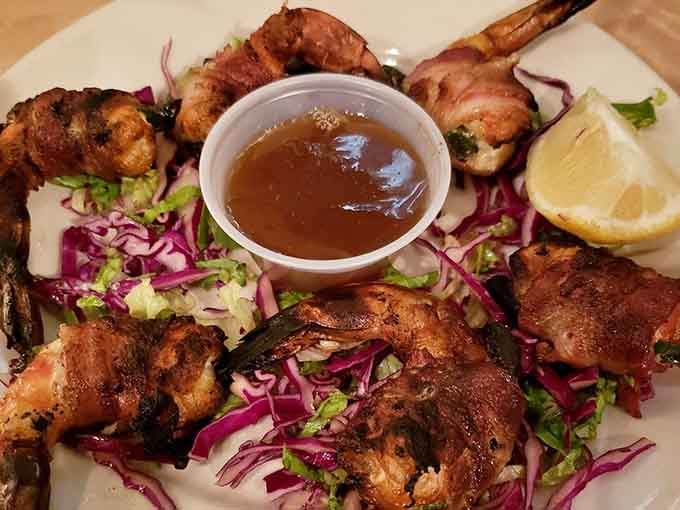 Bacon-wrapped shrimp with tangy sauce proves that good things really do come to those who order adventurously at restaurants.