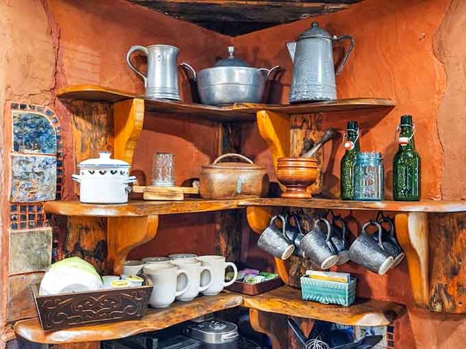 Rustic shelving displays teapots and mugs ready for elevenses, luncheon, and afternoon tea.