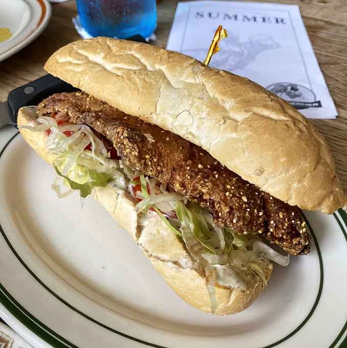 The catfish po'boy delivers crispy, seasoned fish on crusty bread with all the fixings a sandwich needs.