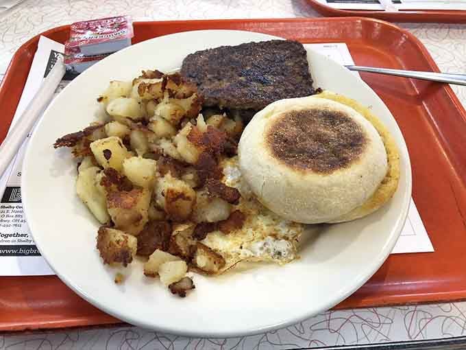 Breakfast done right: eggs, hash browns, and sausage creating the kind of morning magic that fuels entire days.