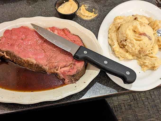 The knife says it all: this prime rib is so tender it practically cuts itself, mashed potatoes standing by.
