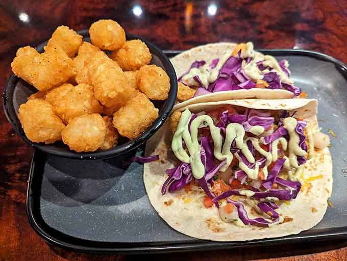 Tacos paired with tater tots is the kind of menu creativity that deserves its own award category somewhere.