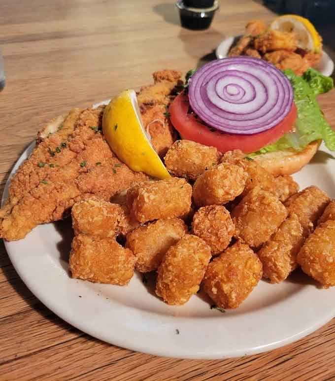 Golden catfish nestled in a bun with crispy tots proves Southern comfort food never goes out of style.