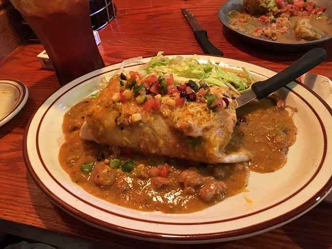 This burrito arrives smothered in green chili and cheese, basically Colorado's answer to a warm, delicious hug.