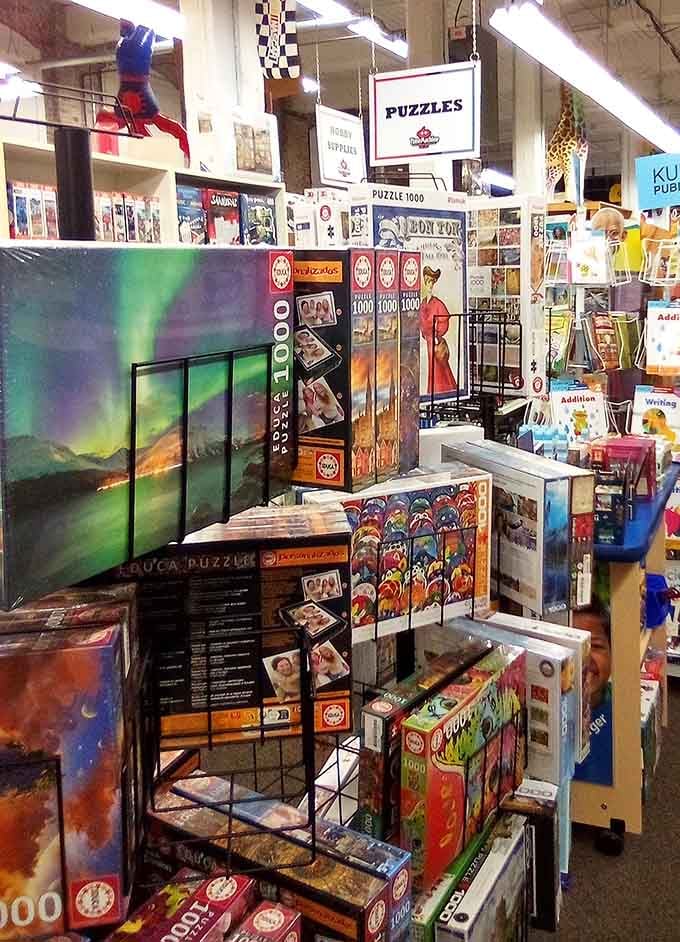Puzzles stacked to the ceiling because sometimes the best entertainment doesn't require batteries or Wi-Fi.