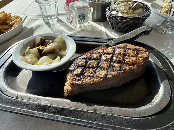 That New York Strip on a sizzling platter arrives at your table announcing itself like a celebrity entrance.