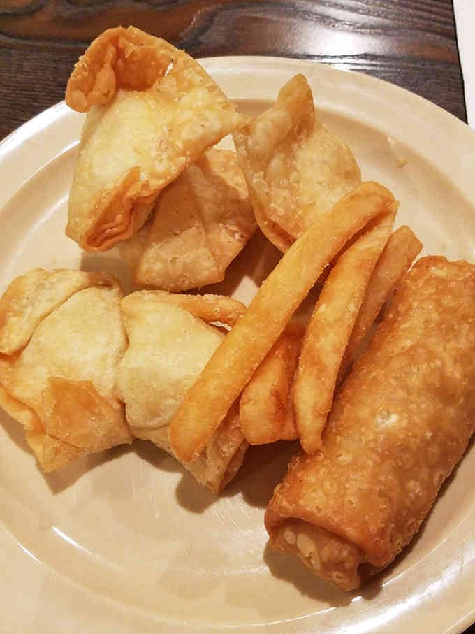 Crab rangoon and spring rolls sitting there looking innocent, but one bite changes everything you thought you knew.