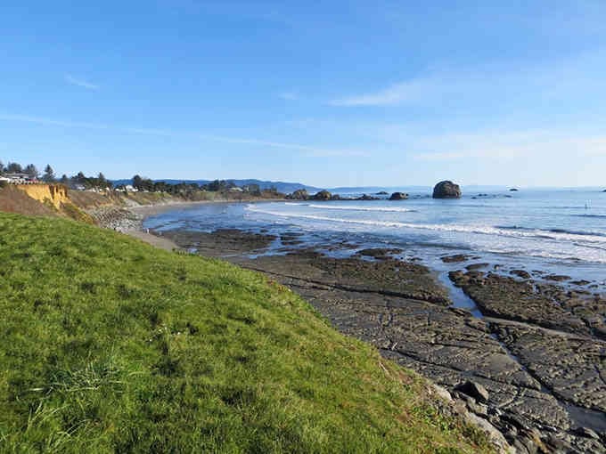 Rocky outcrops dot the coastline where the ocean meets the shore in an endless, timeless dance of waves.