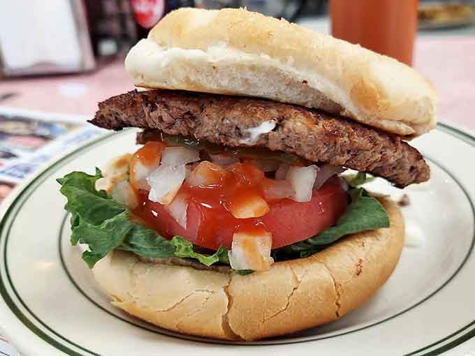 A burger so photogenic it doesn't need filters, just hunger and maybe some extra napkins nearby.