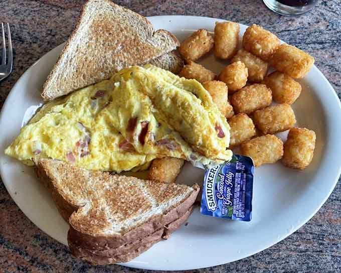 A fluffy omelet paired with crispy taters makes mornings worth waking up for, even if it's technically 3 PM.