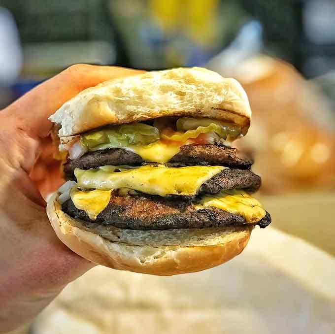 This triple-decker cheeseburger situation is what happens when ambition meets appetite in the most glorious way possible.