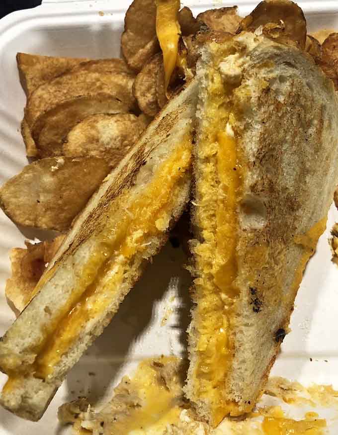 Crab and cheese getting cozy between buttered bread, because Maryland knows how to do grilled cheese properly.