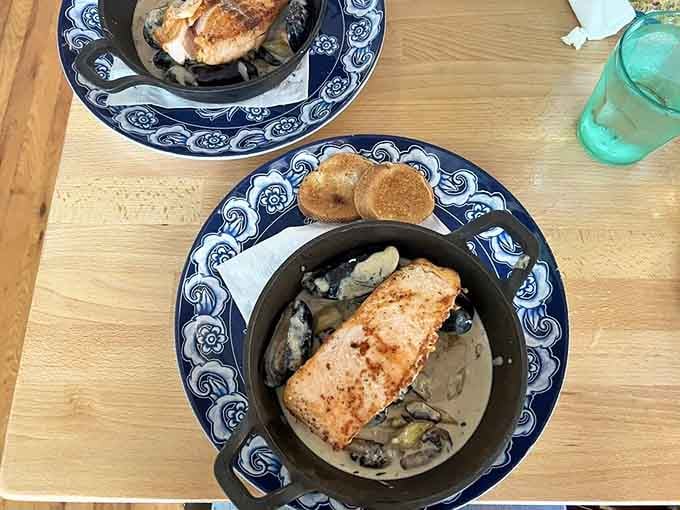 Zeeland Salmon arrives in a cast-iron skillet like edible treasure, proving seafood travels well to landlocked Missouri.
