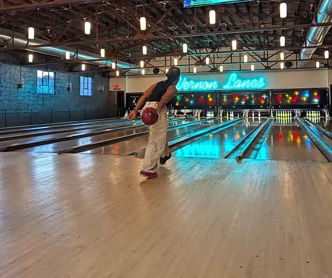 Perfect form captured mid-release, proving that style matters even when you're just trying to hit some pins.