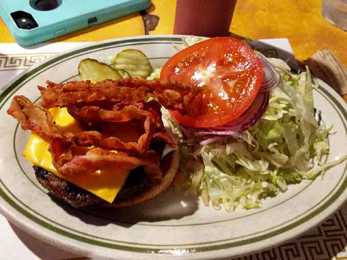 That bacon cheeseburger comes loaded with enough toppings to require architectural engineering and multiple napkins to consume properly.