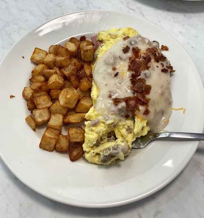 The Country Music Star Omelette arrives smothered in sausage gravy, because sometimes more is exactly what you need.