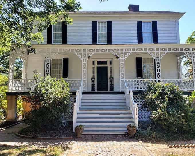 That ornate porch work frames the entrance like delicate lace on a Sunday dress, inviting you to step back in time.