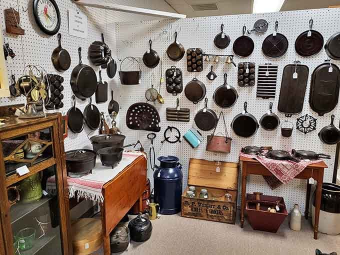 Cast iron cookware hanging like culinary art, built to outlast your great-grandchildren's great-grandchildren.