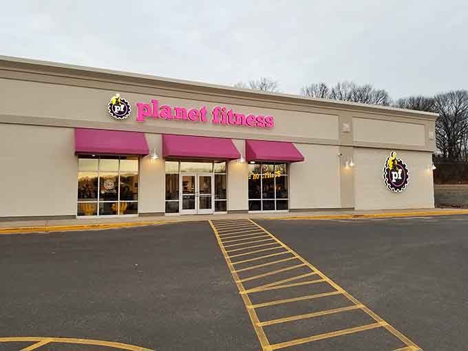 Even Planet Fitness looks inviting here, though we both know those good intentions last about three weeks, tops.