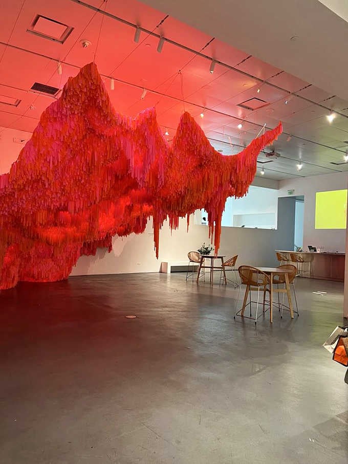 Cascading crimson fabric creates a dramatic mountain range that would make any interior designer weep with envy.